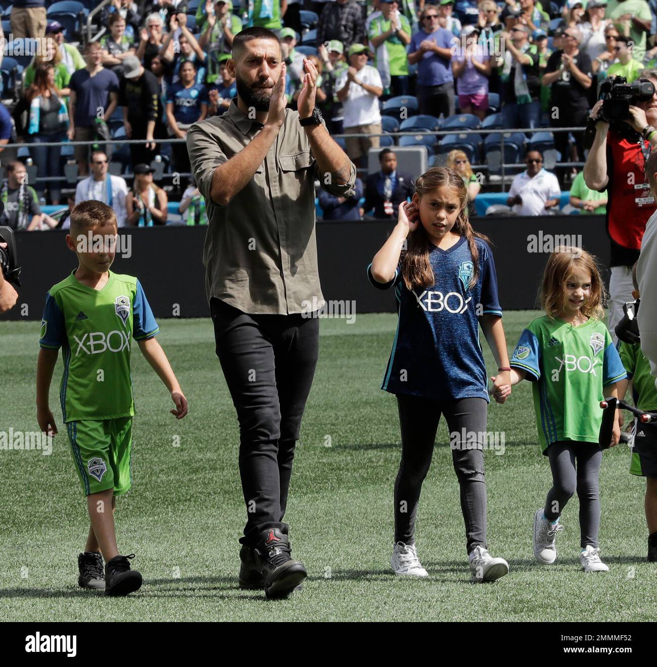 Seattle Sounders forward Clint Dempsey, second from left, walks with ...