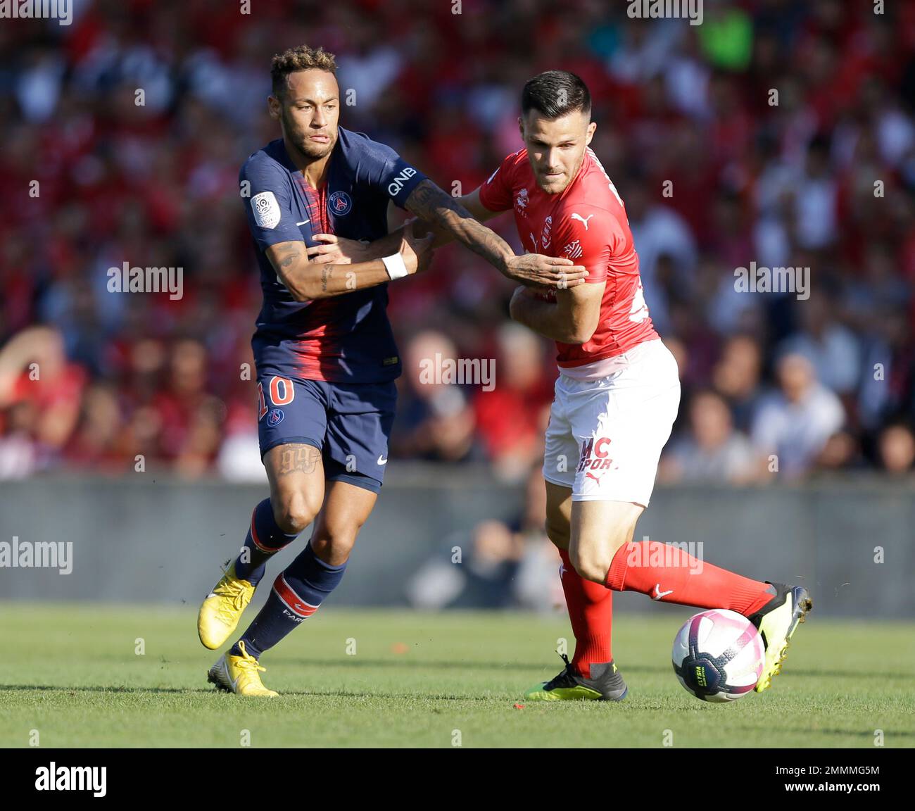 PSG's Neymar, left, vies the ball with Nimes' Sami Ben Amar during ...