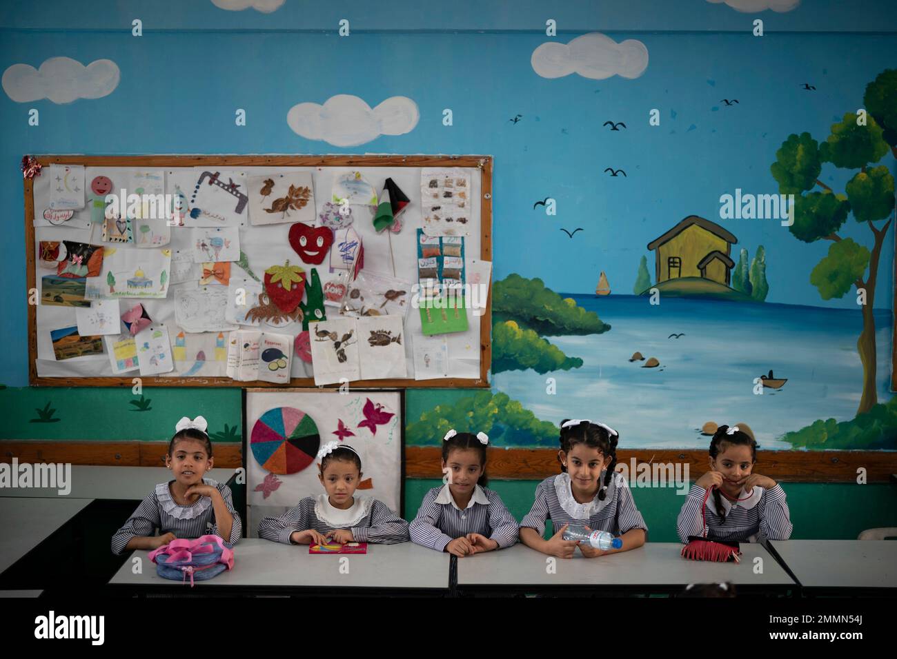 Girls sit inside a classroom at an UNRWA school during the first day of ...