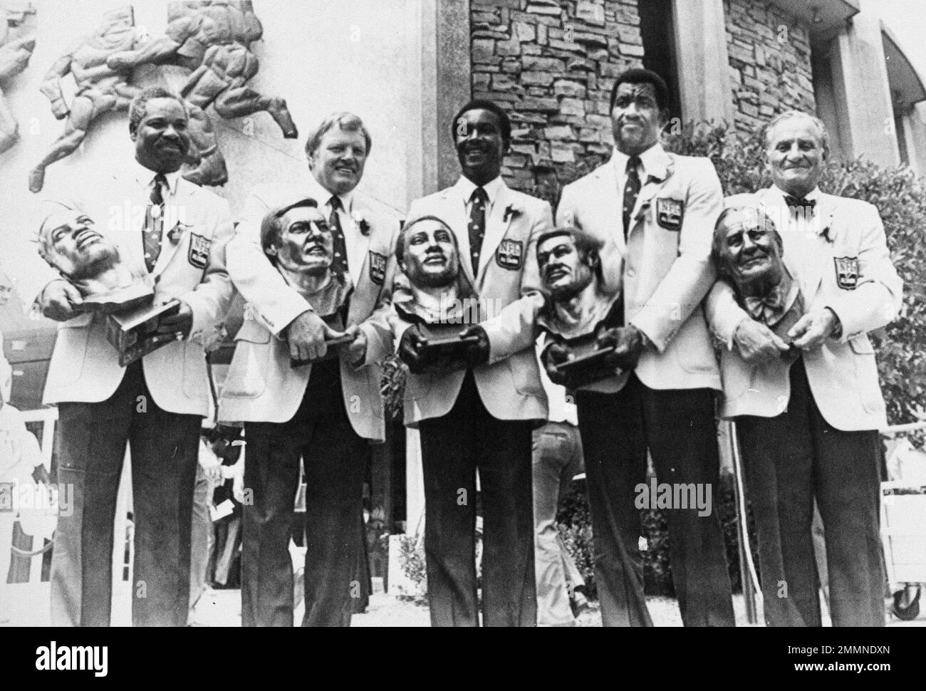 Five inductees into the Pro Football Hall of Fame pose outside the hall ...