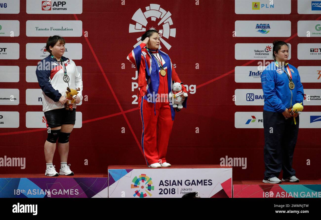 Gold medalist North Korea's Kim Kuk Hyang, center, salutes beside with ...