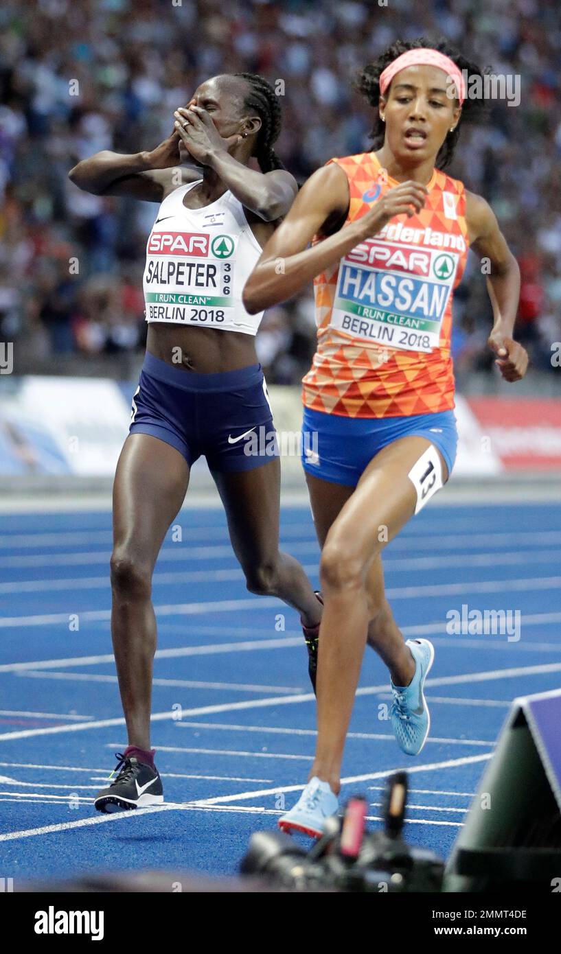 Israel's Lonah Chemtai Salpeter, left, reacts after stopping the race ...