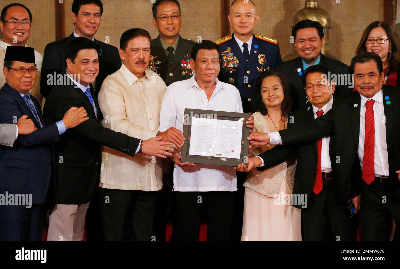 President Rodrigo Duterte, center, and leaders of the Moro Islamic ...