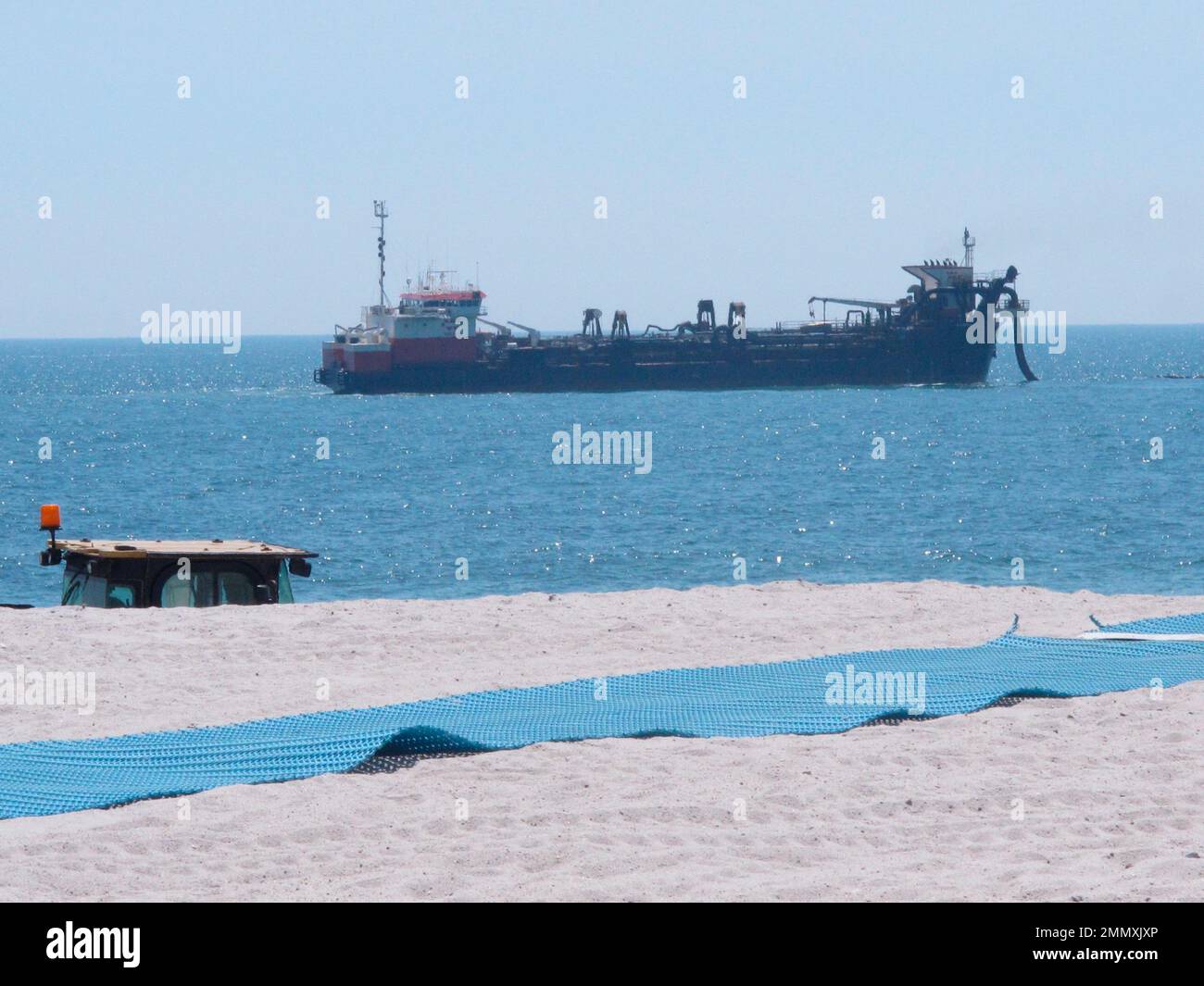 This July 11, 2018 photo shows a ship pumping sand from offshore onto ...