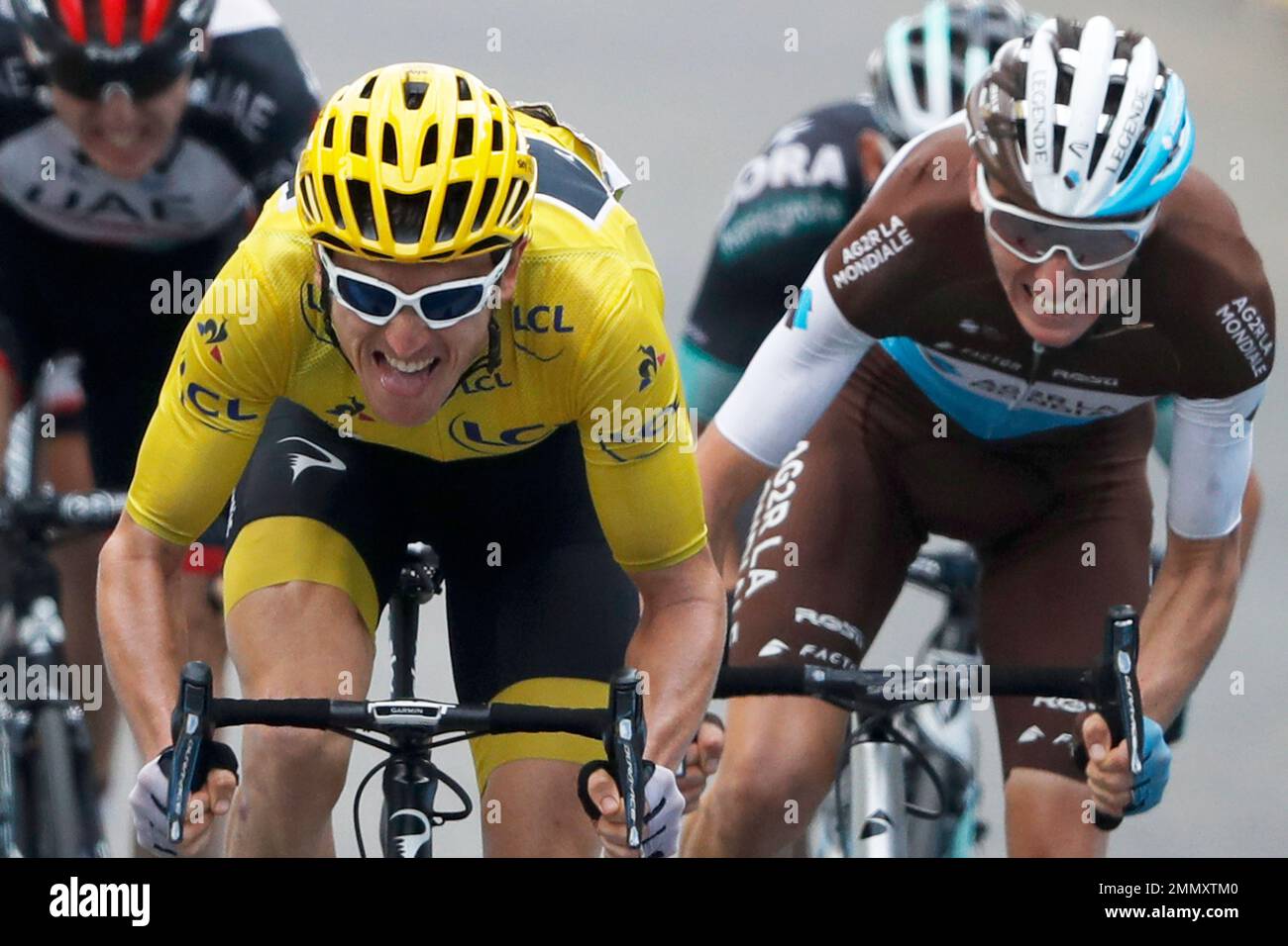 Britain's Geraint Thomas, wearing the overall leader's yellow jersey ...