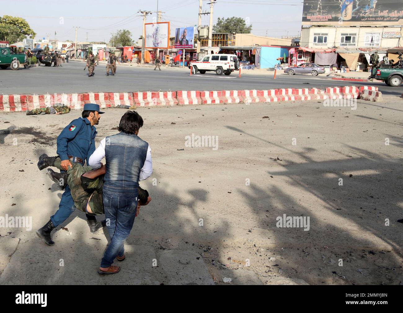 Afghan security personnel carry an injured man after an attack near the ...