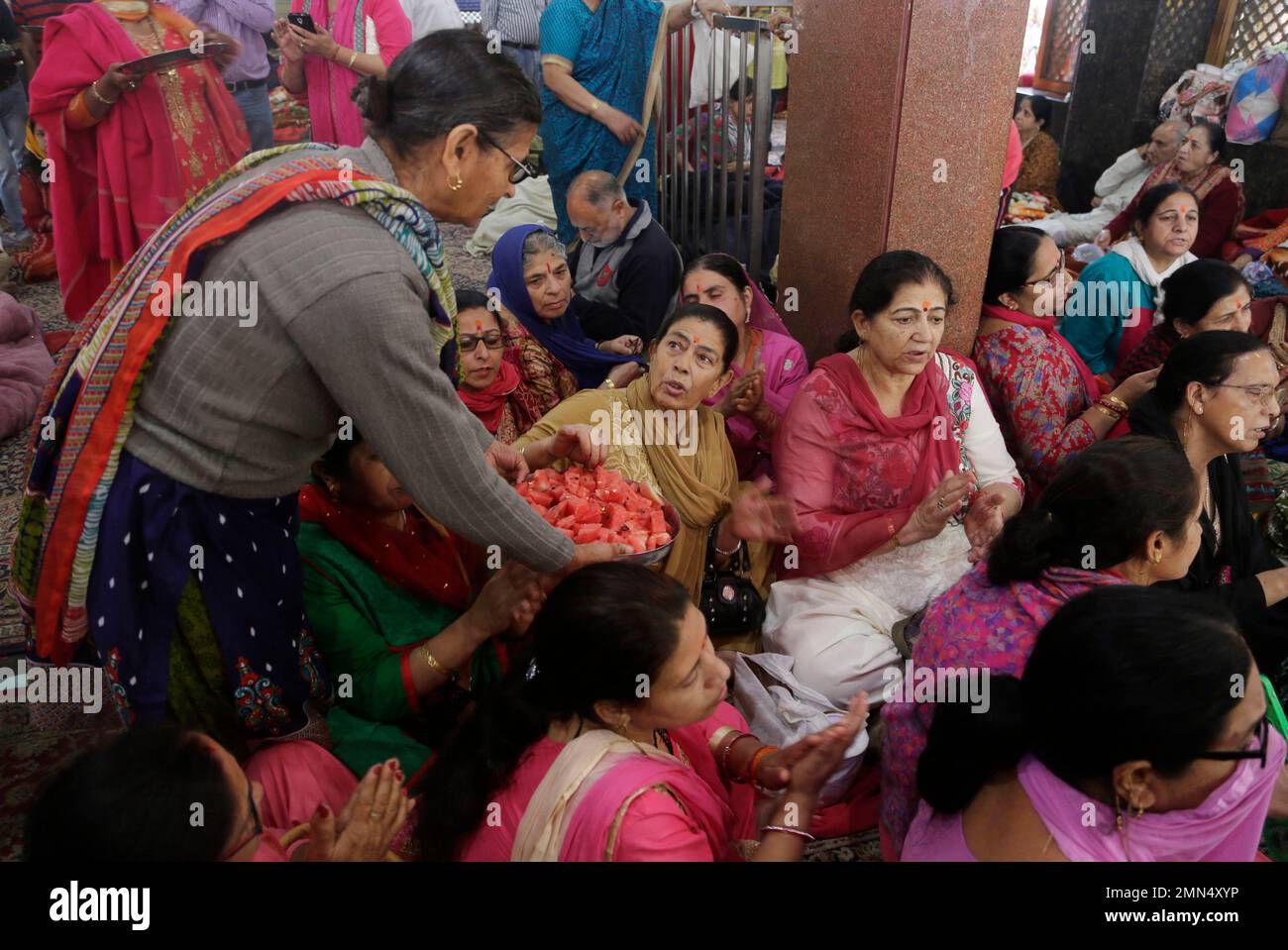 A devotee distributes watermelon as Kashmiri Hindu devotees known as ...