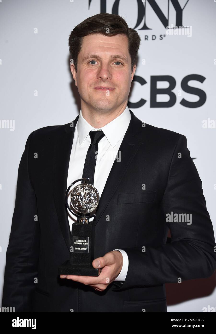 Neil Austin poses in the press room with the award for best lighting ...