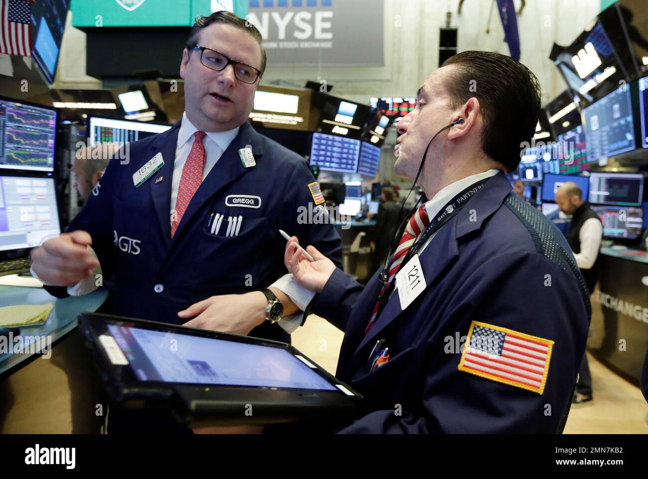 Specialist Gregg Maloney, left, and trader Tommy Kalikas work on the ...