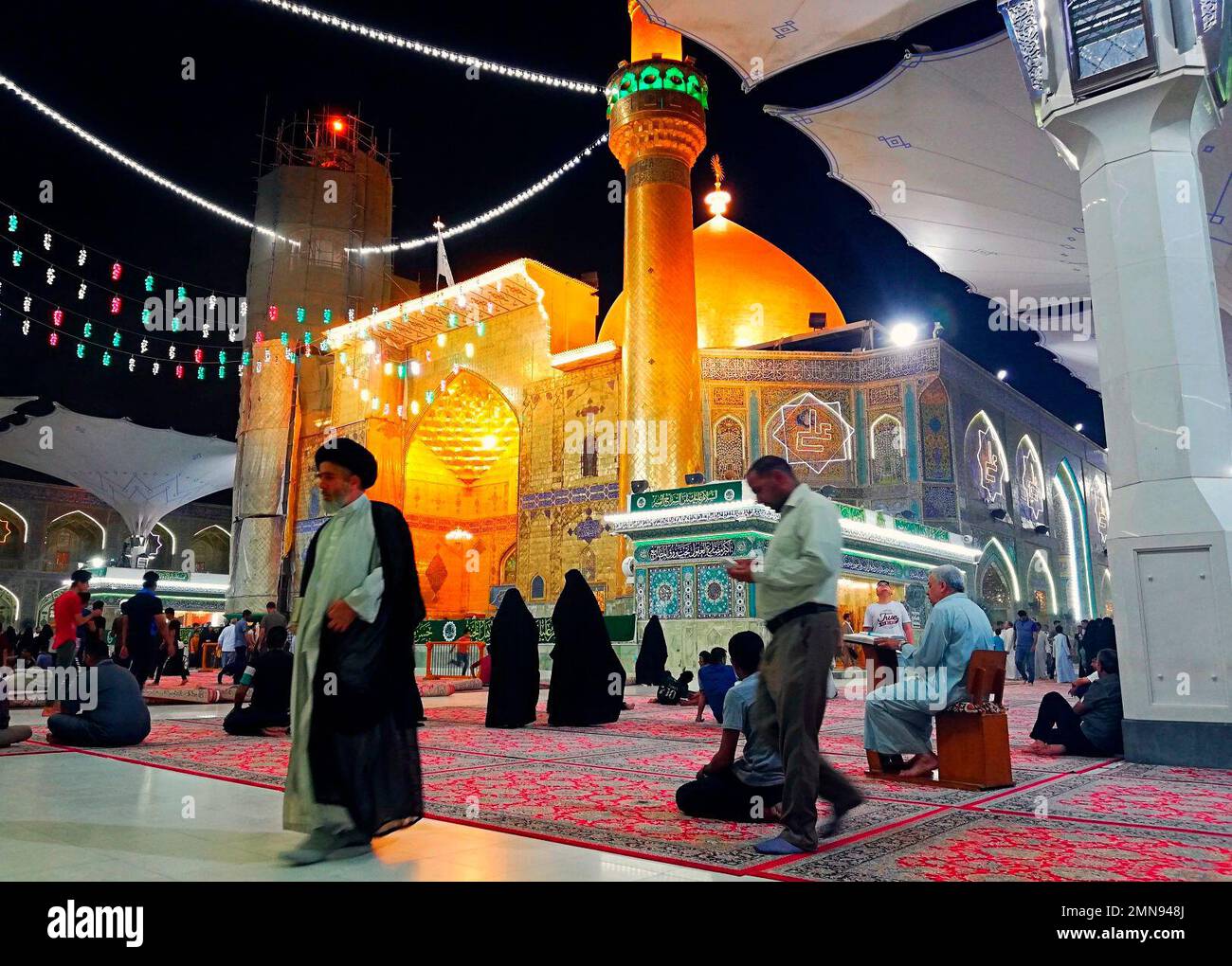 Shiite Muslim worshippers gather outside the holy shrine of Imam Ali ...