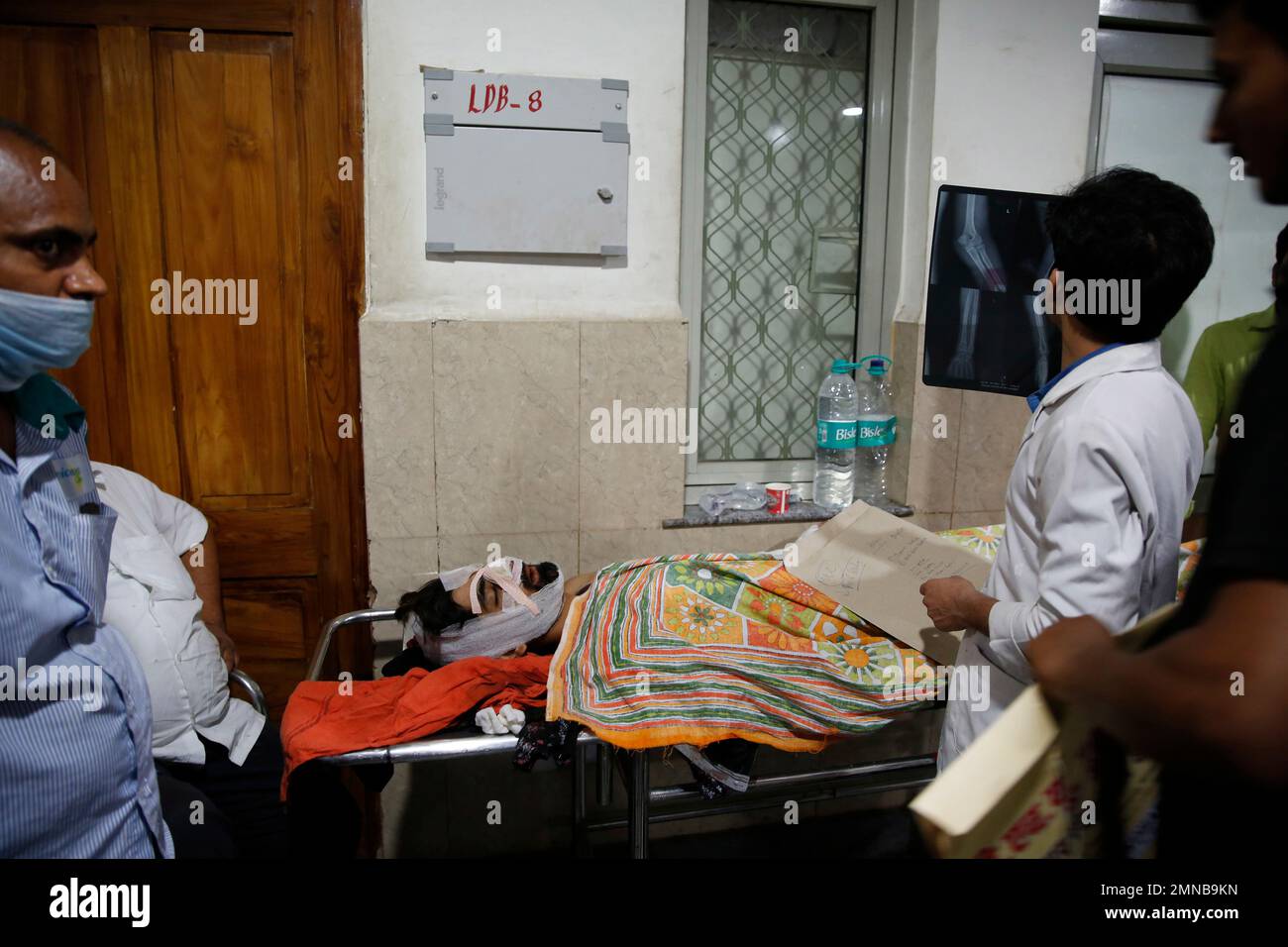 A doctor looks at the X-rays of victim Ranjan, 37, at the Trauma Centre ...