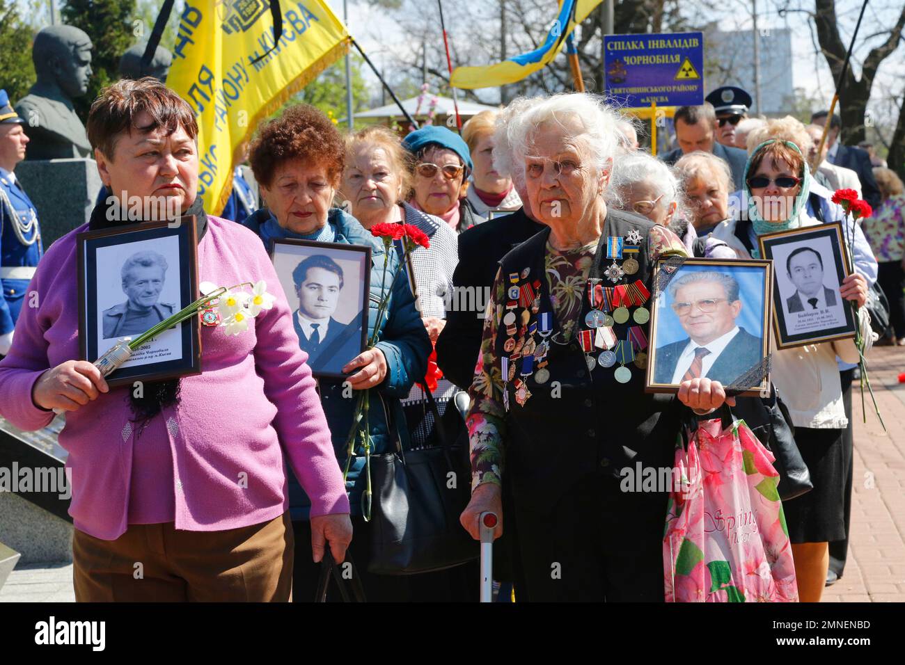 Widows of Chernobyl victims hold portraits of their husbands who died ...