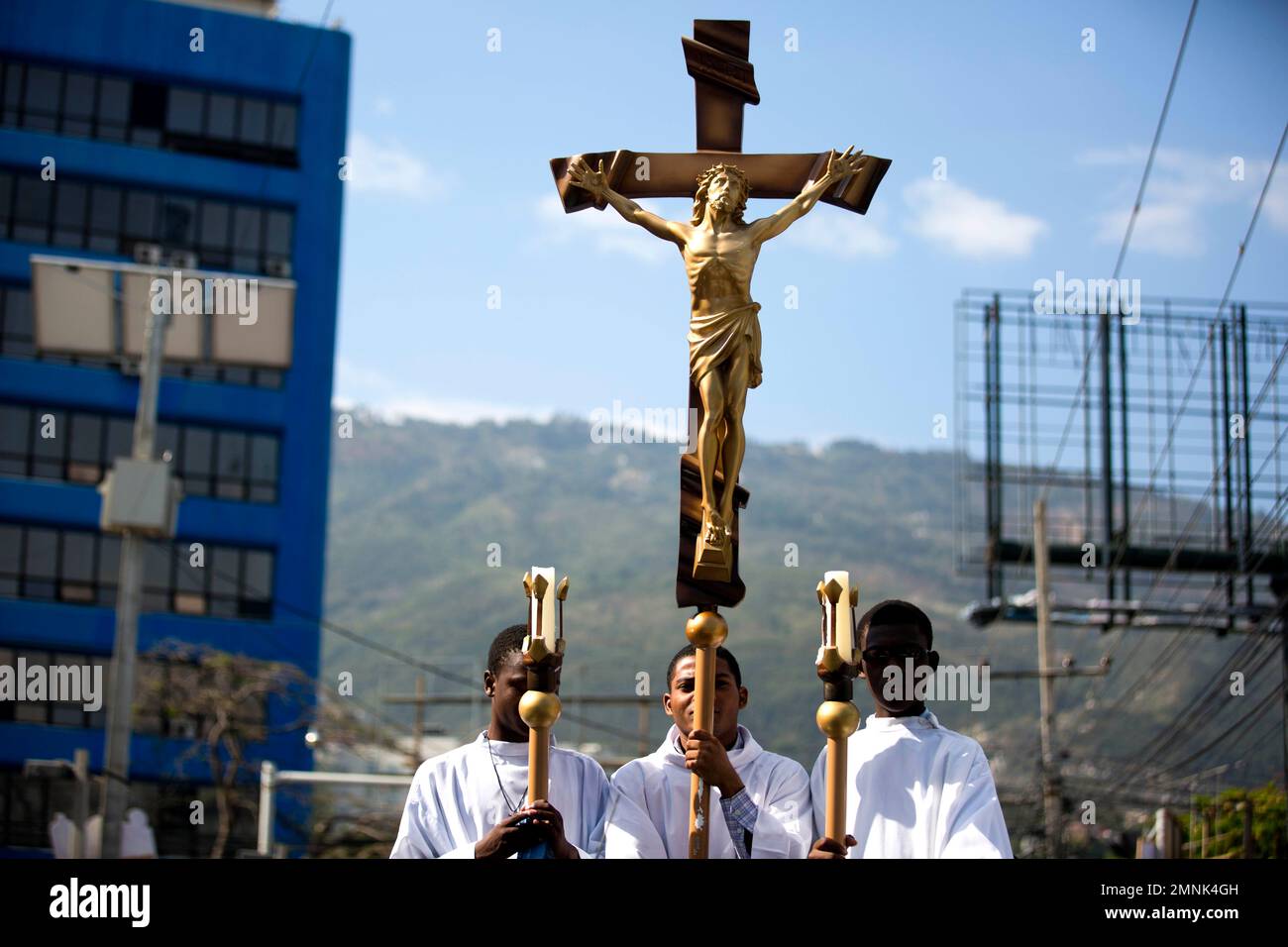 Altar boys lead devotees to the fifth station in the Way of the Cross ...
