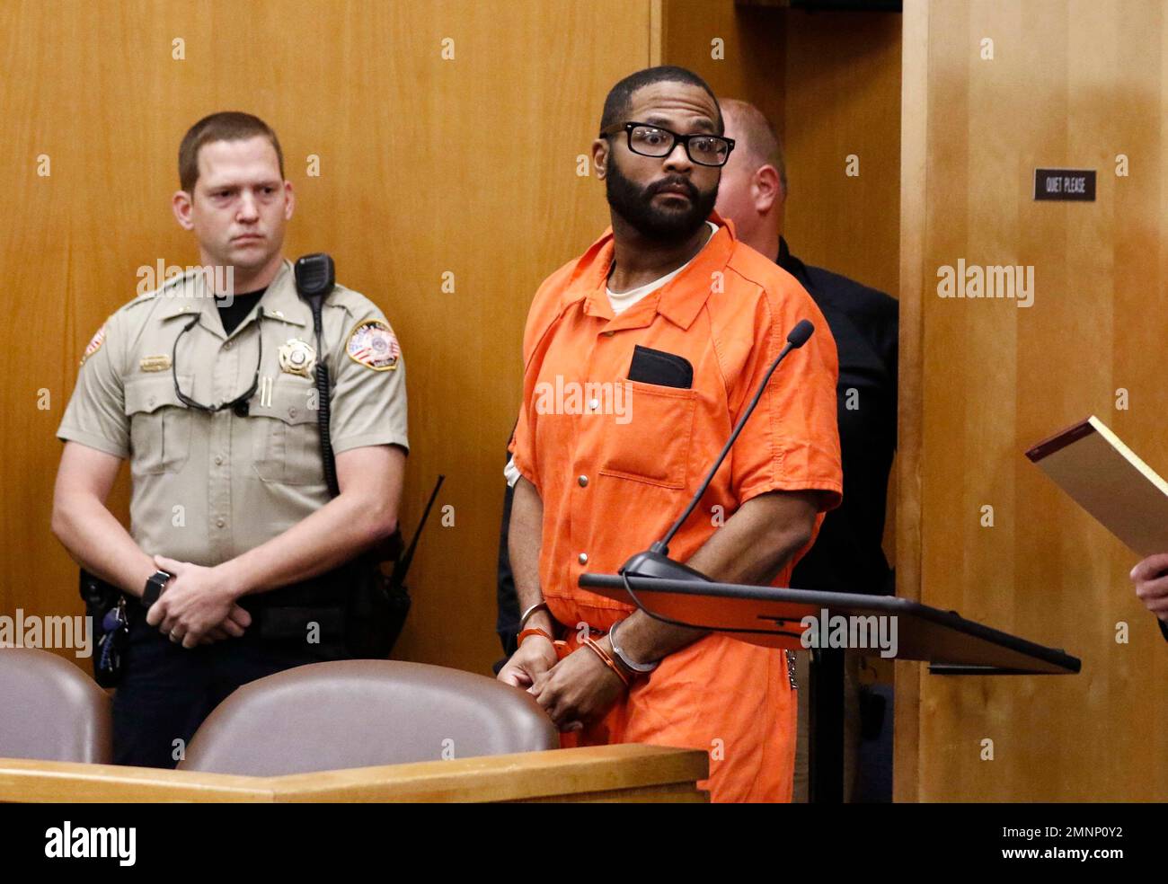 Willie Cory Godbolt, right, escorted by a lawman, looks around the ...