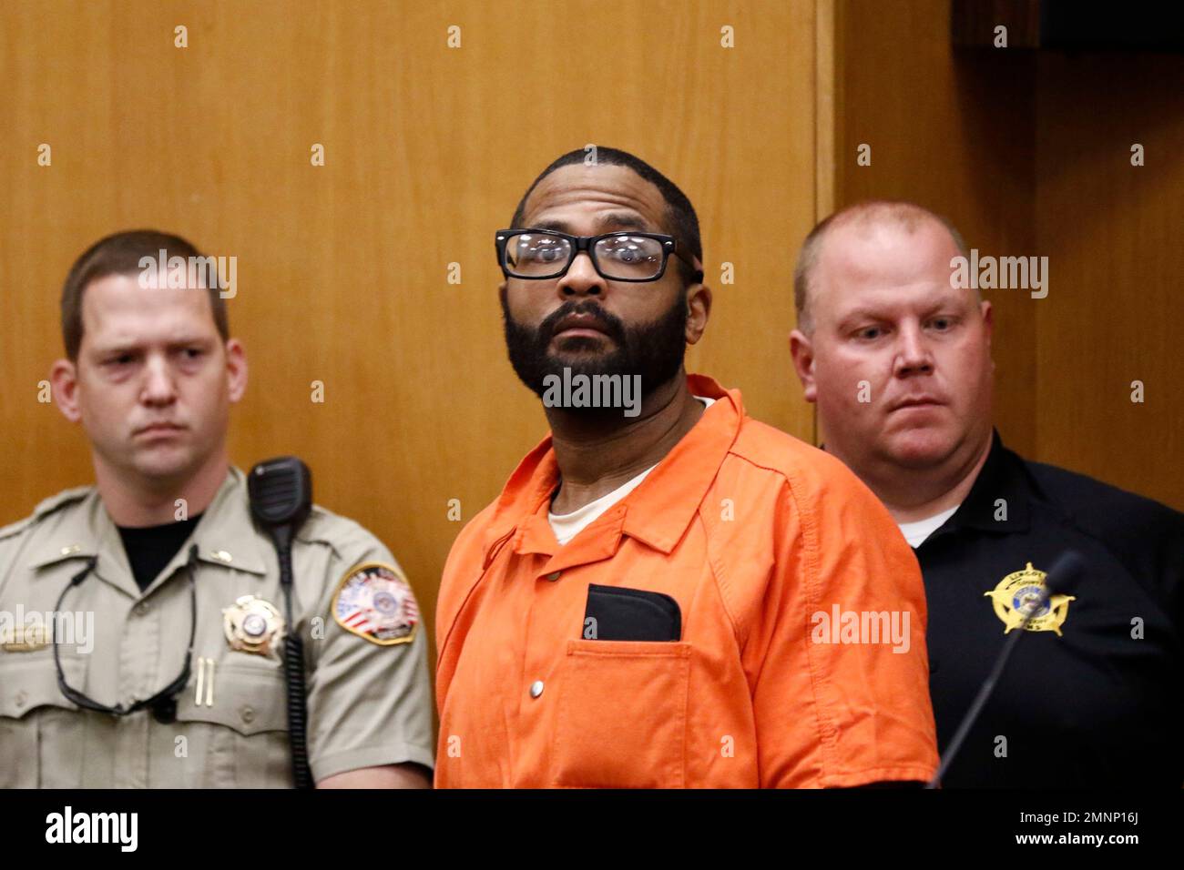 Willie Cory Godbolt, center, escorted by lawmen, looks around the ...