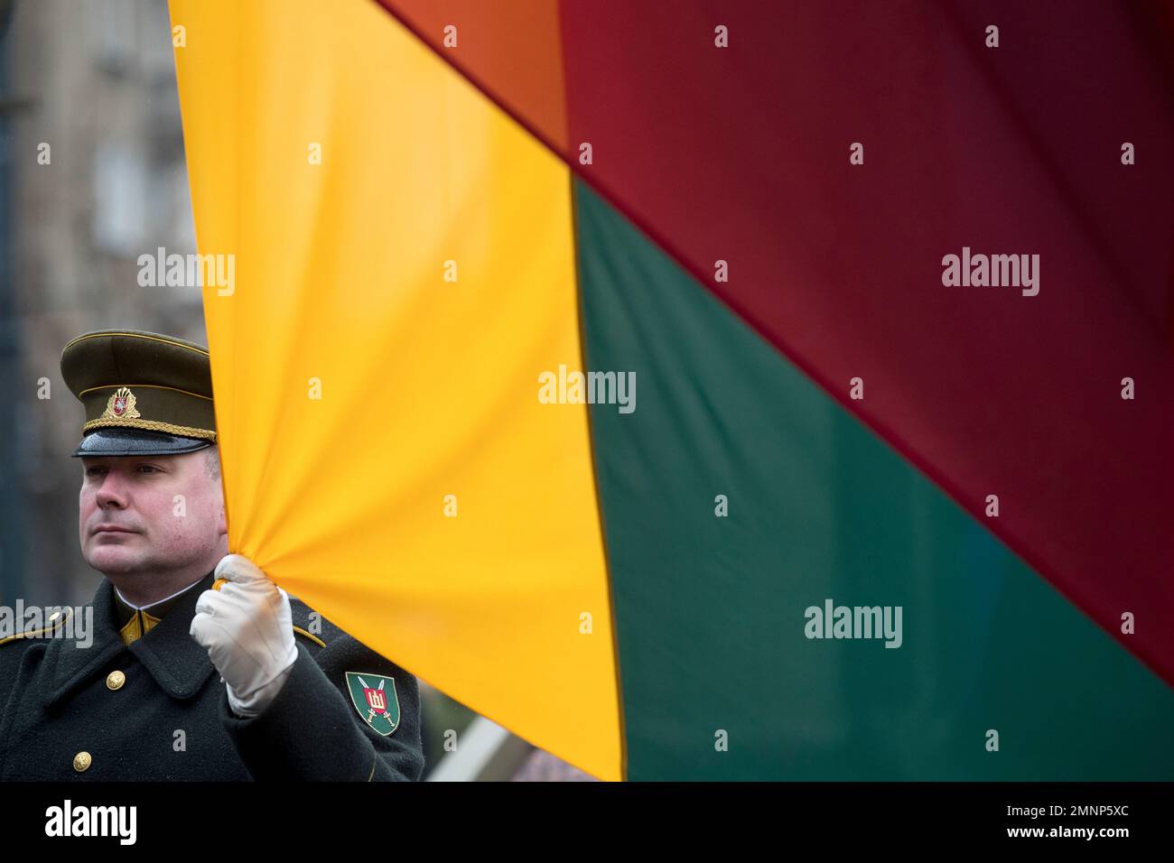 A soldier of Lithuania's Army hold national flags during a celebration ...
