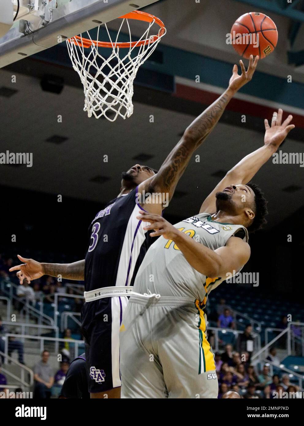 Stephen F. Austin forward Leon Gilmore III (3) and Southeastern ...
