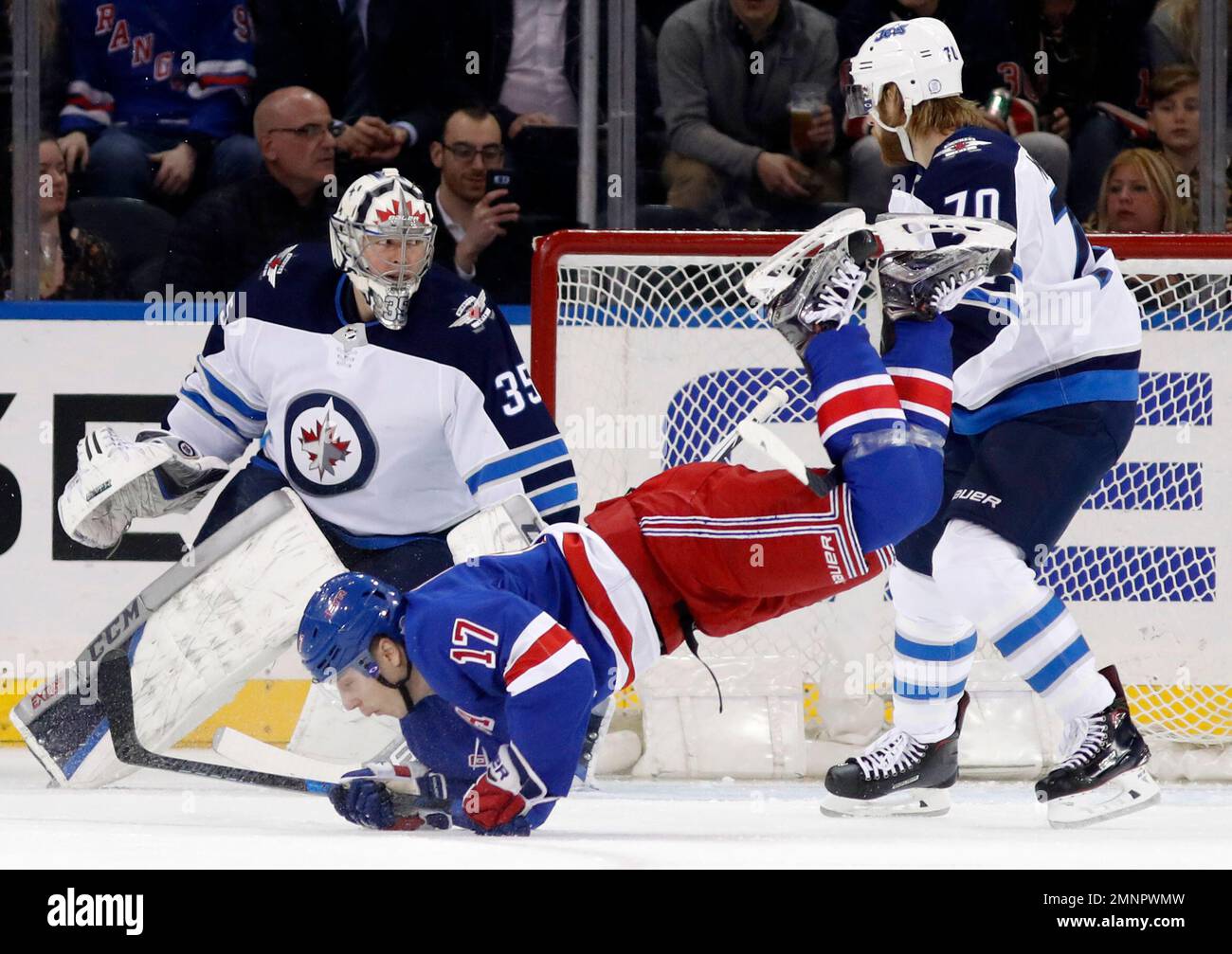 New York Rangers right wing Jesper Fast (17) of Sweden trips in front ...