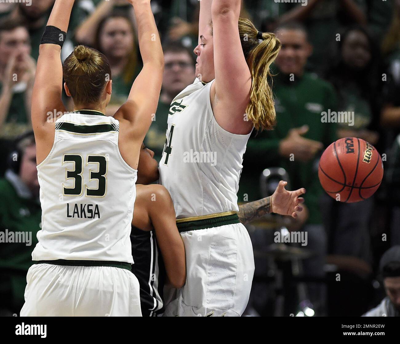 South Florida's Kitija Laksa, left, and Alyssa Rader, right, pressure ...