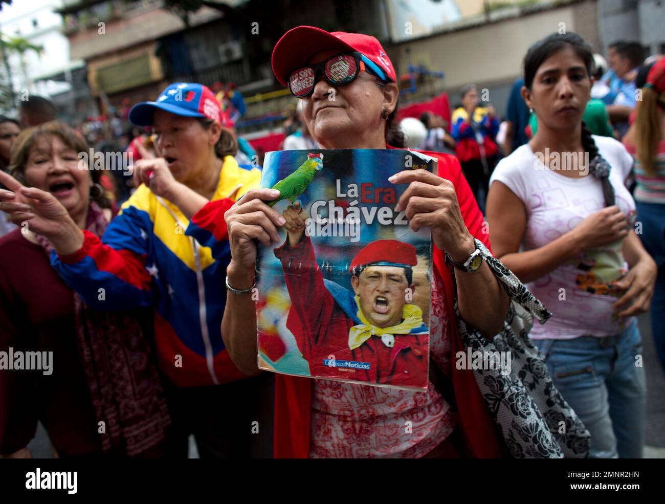 A government supporter holds a poster with the image of Venezuela's ...