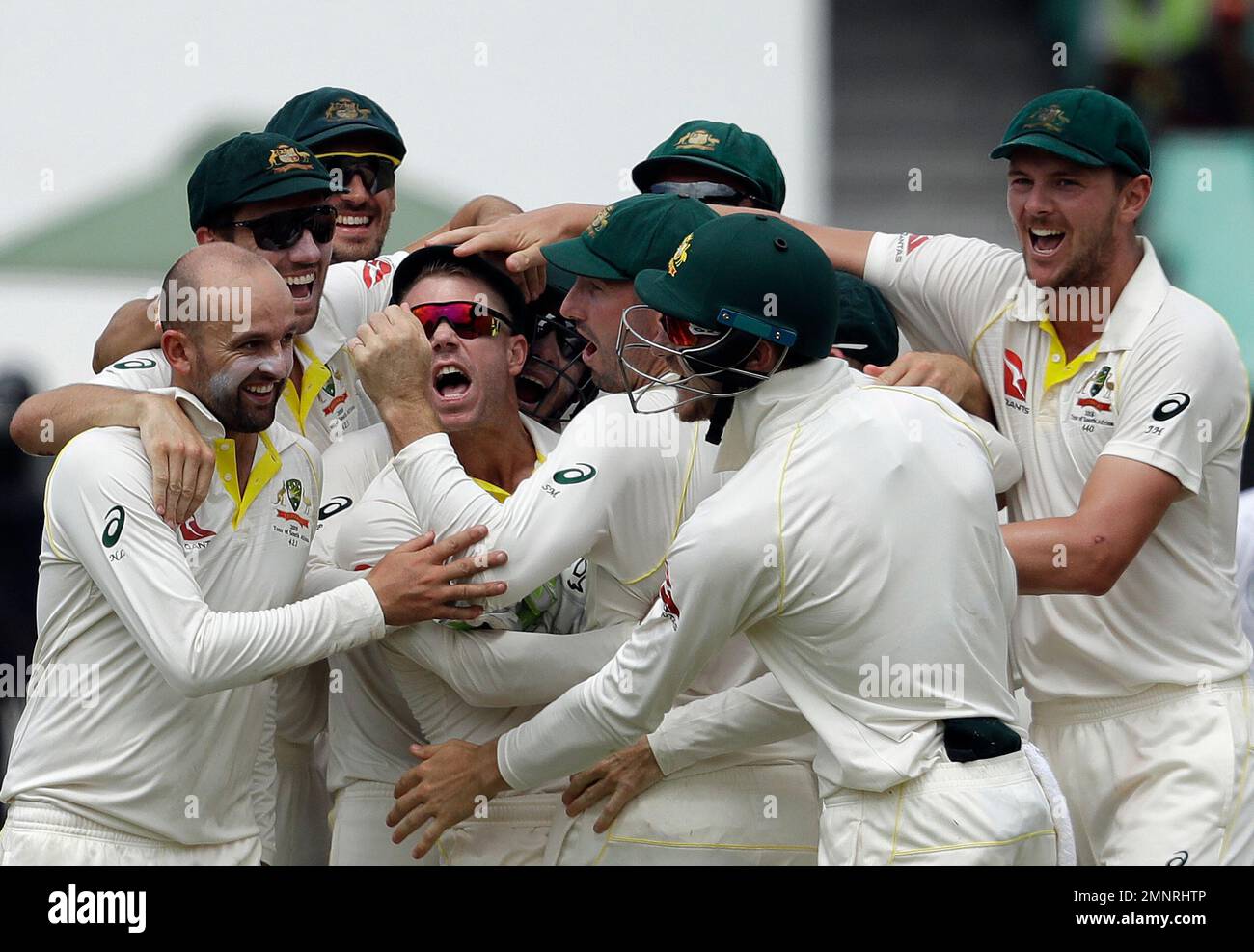 Australia's bowler Nathan Lyon, left, and teammates celebrate, after ...