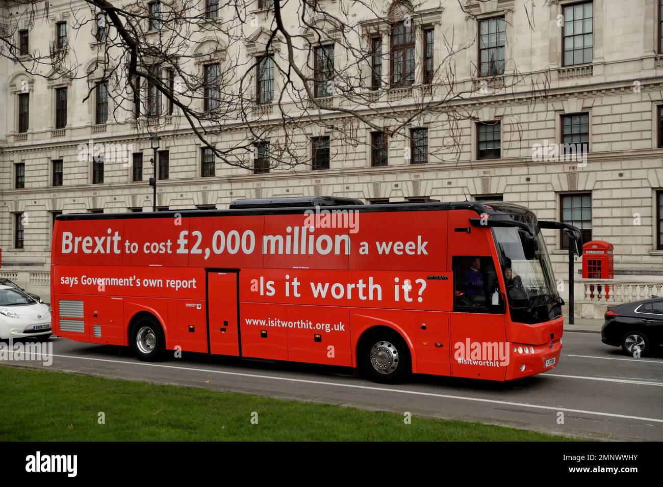 A bus bearing the words "Brexit to cost £2,000 million a week" drives ...