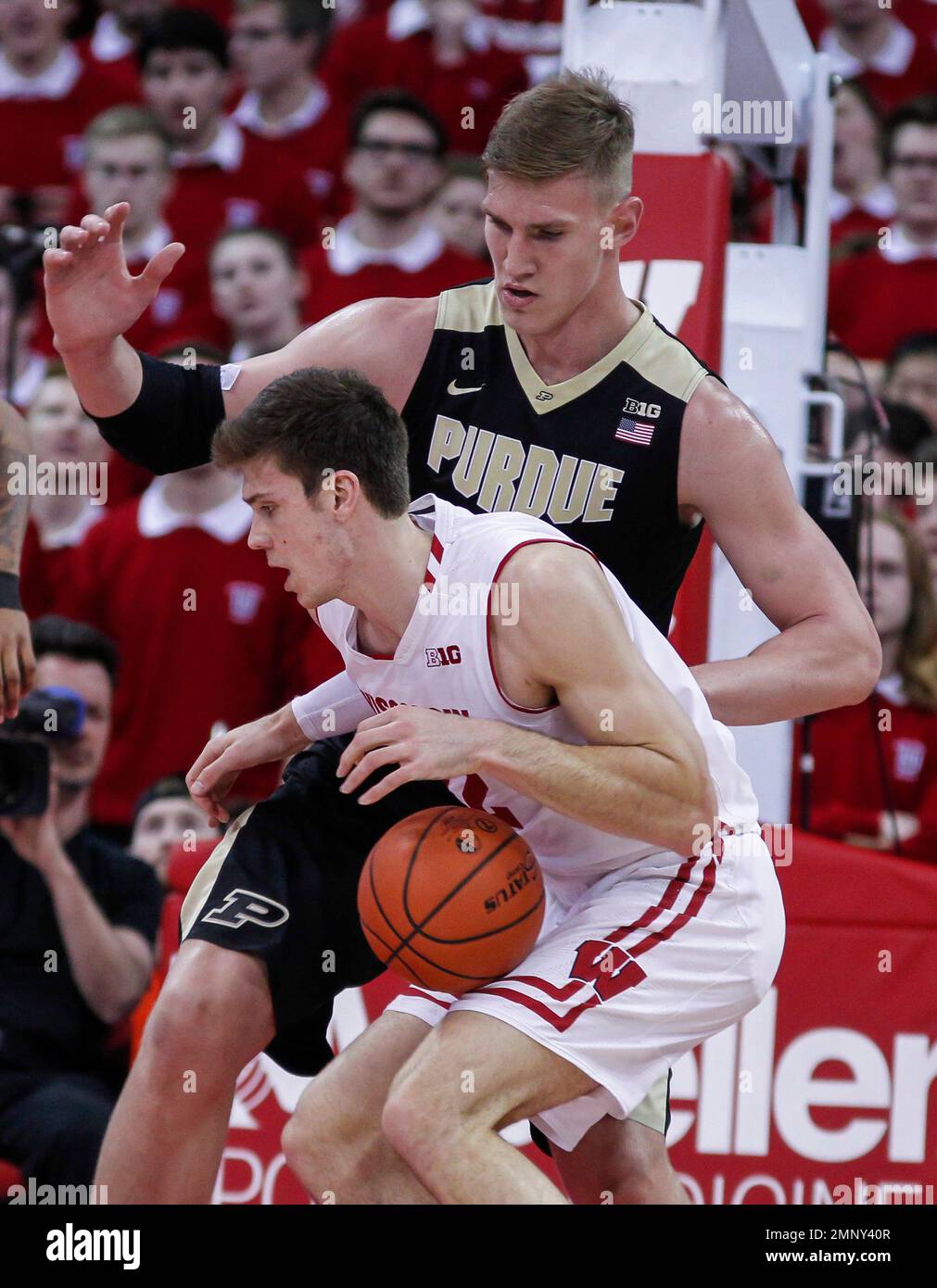 Wisconsin's Ethan Happ (22) drives on Purdue's Isaac Haas during the ...