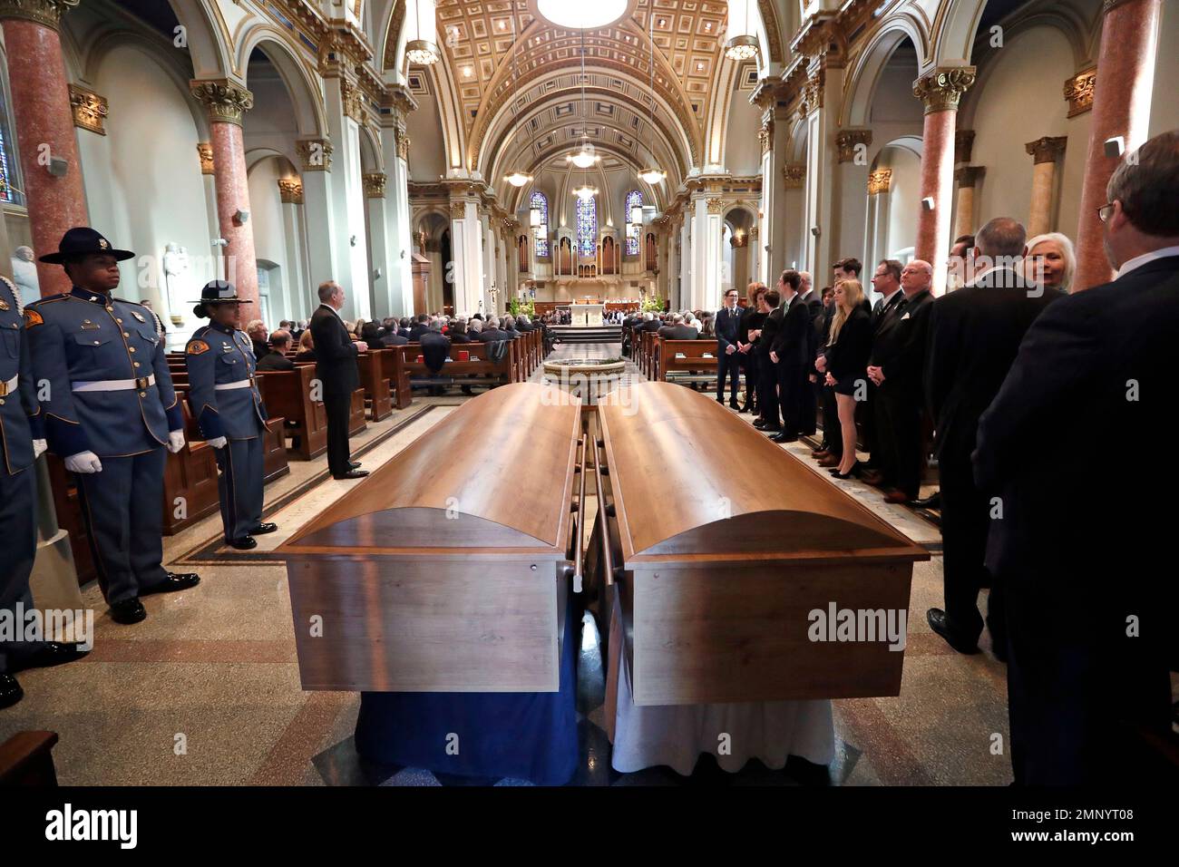 A Washington State Patrol honor guard, left, stands ready to move the ...