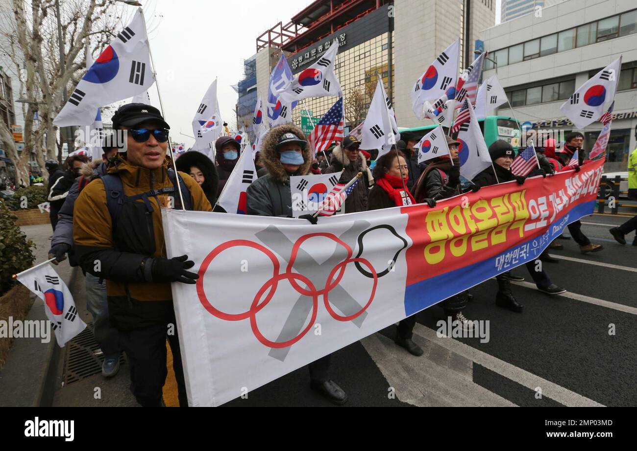 Protesters march after a rally against North Korea's participation in ...
