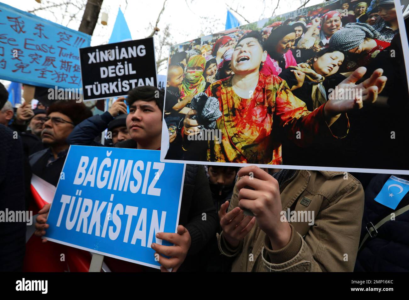 Several hundred Uighurs living in Turkey carrying Turkish and flags of ...