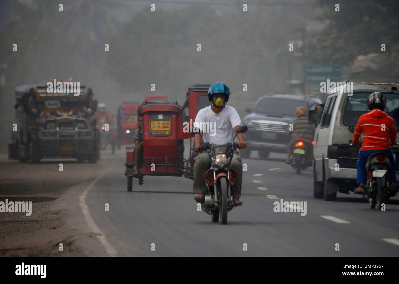 Motorists use face masks as volcanic ash from Mayon volcano's eruption ...
