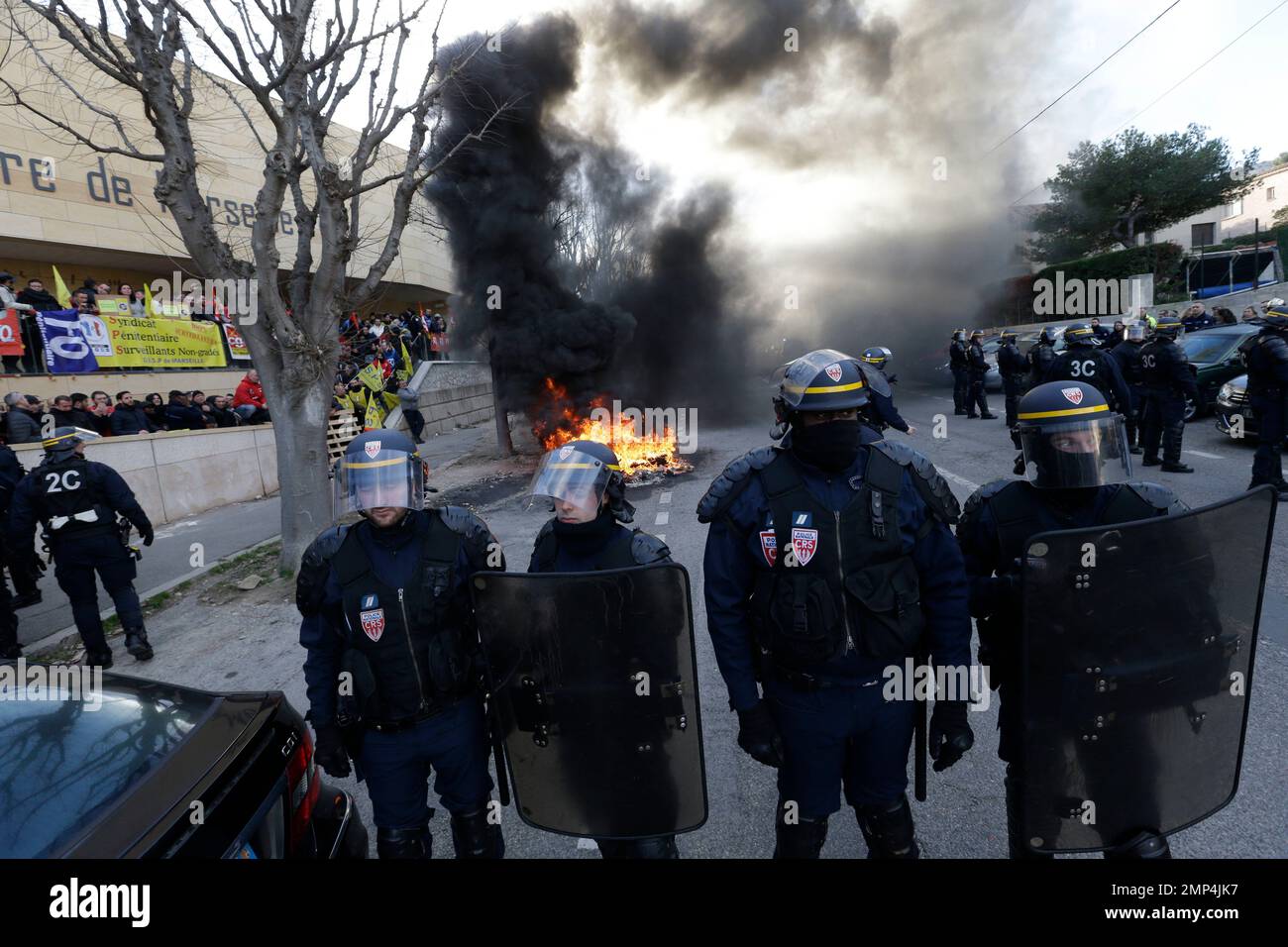 Riot police officers stand guard outside the Baumettes prison during as ...