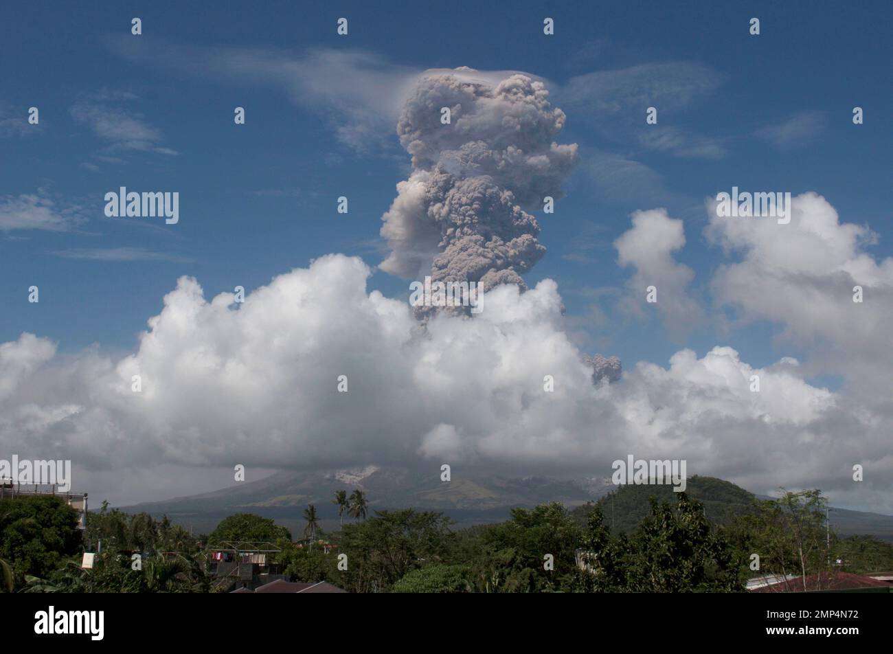 A huge column of ash shoots up to the sky during the eruption of Mayon ...
