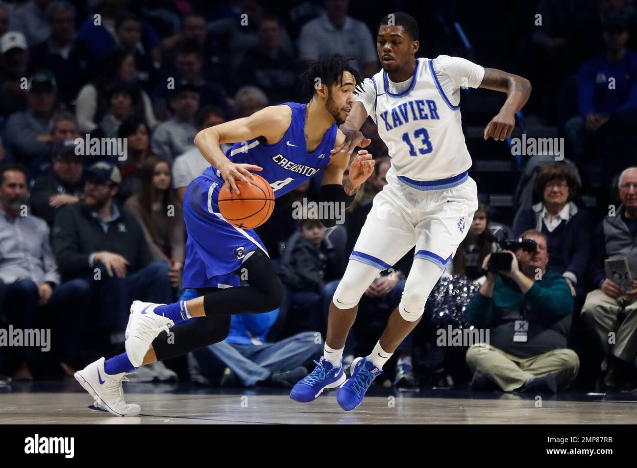 Creighton's Ronnie Harrell Jr. (4) drives against Xavier's Naji ...