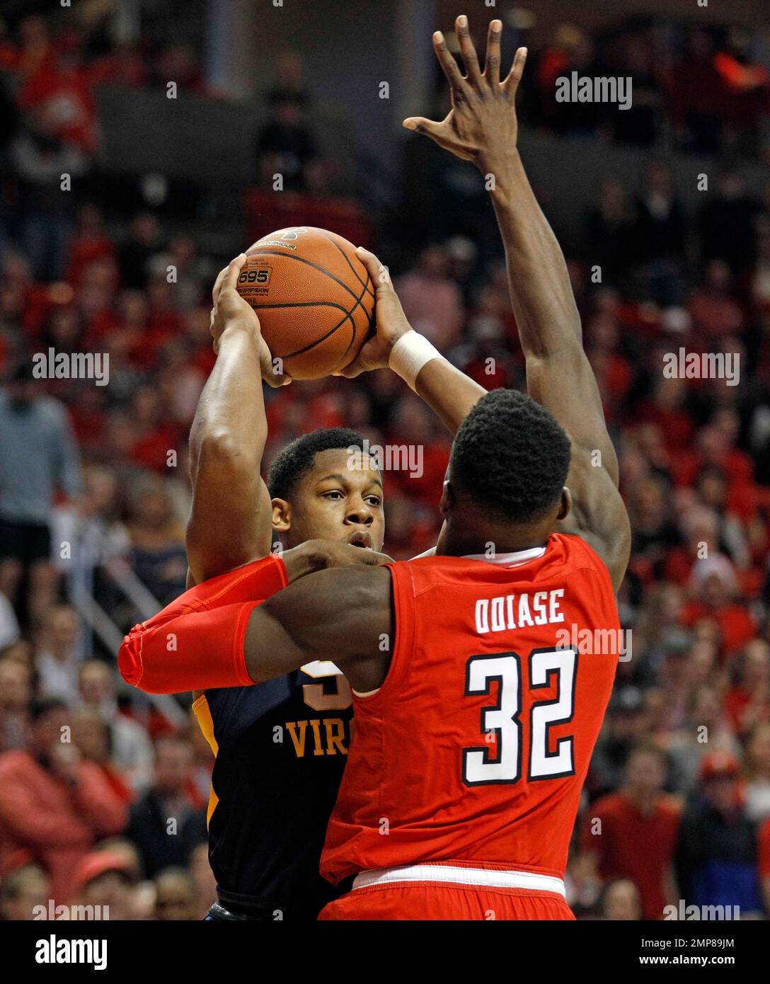 West Virginia's Sagaba Konate (50) looks to pass the ball around Texas ...