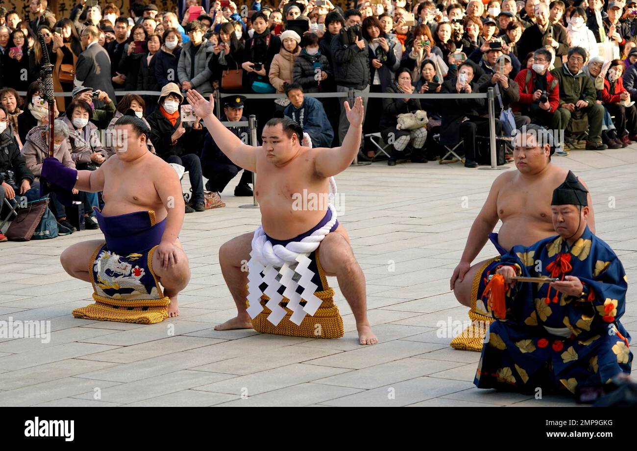 Sumo grand champion Kakuryu, second from left, of Mongolia performs his ...