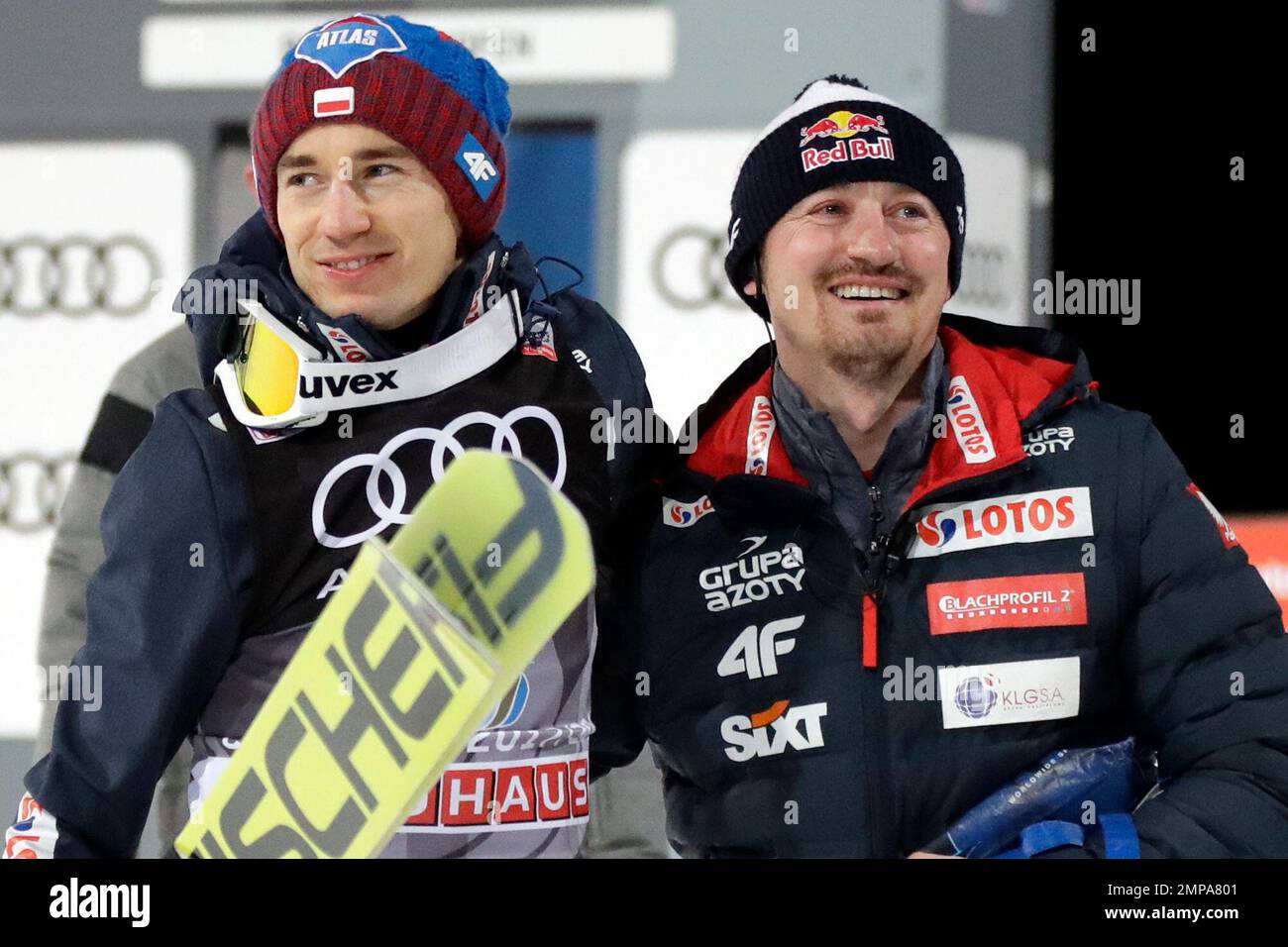 Winner Poland's Kamil Stoch, left, and former ski jumper Adam Malysz ...