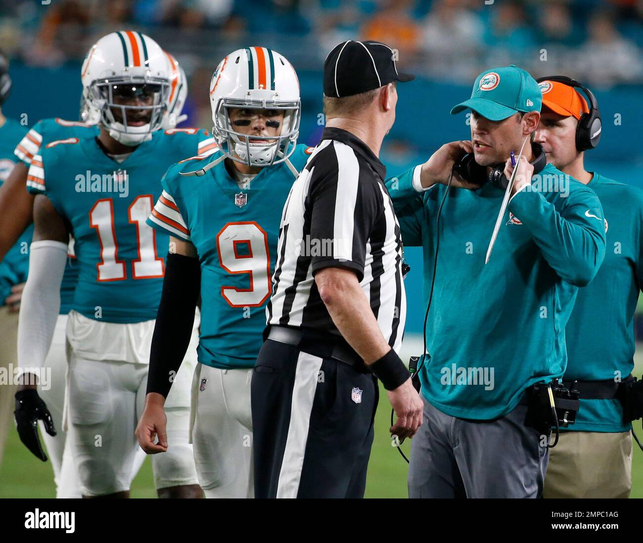 Miami Dolphins head coach Adam Gase talks to side judge Terry Brown ...