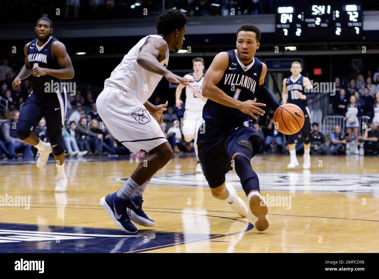 Villanova guard Jalen Brunson, right, brings the ball up court in front ...