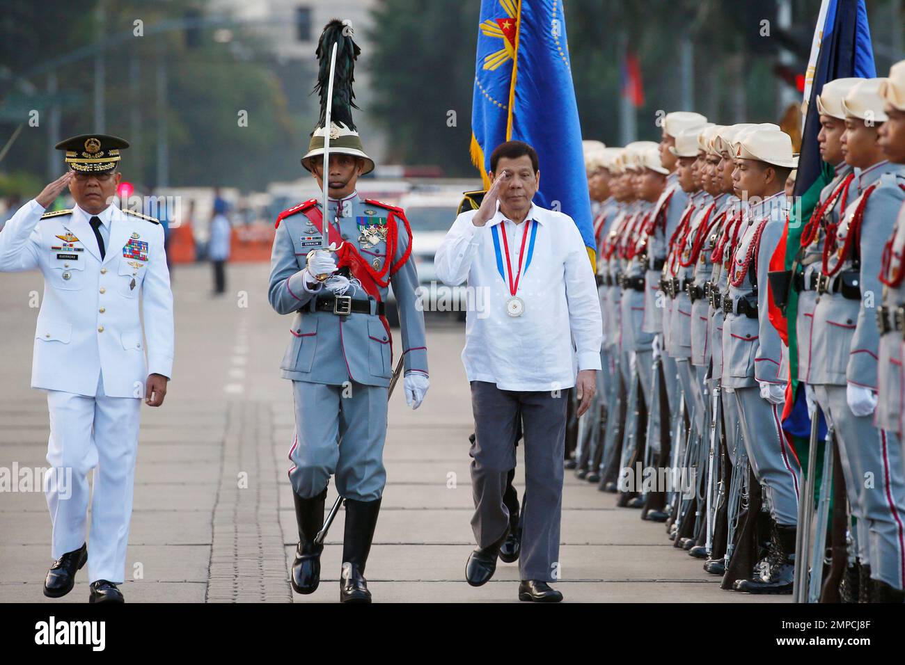 Philippine President Rodrigo Duterte, third from left, salutes as he ...