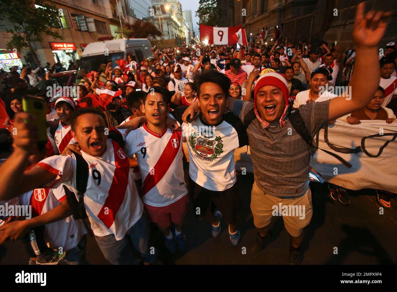 Peruvians who live in Chile shout slogans in favor of the Peruvian soccer team prior to a play ...