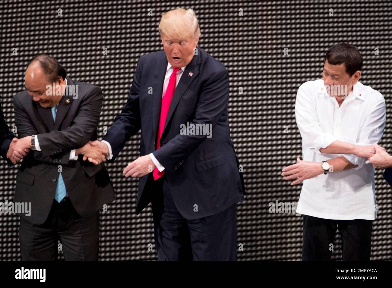 U.S. President Donald Trump, center, reacts when he realizes he is ...