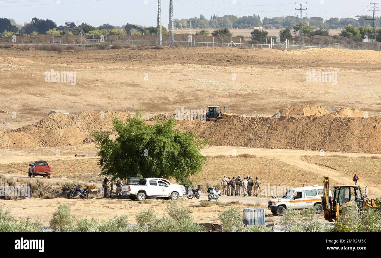 Hamas security forces secure the area while Palestinian bulldozers, at ...
