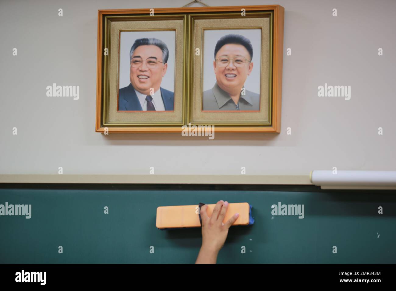 In this Sept. 26, 2017 photo, a student cleans the blackboard under the ...