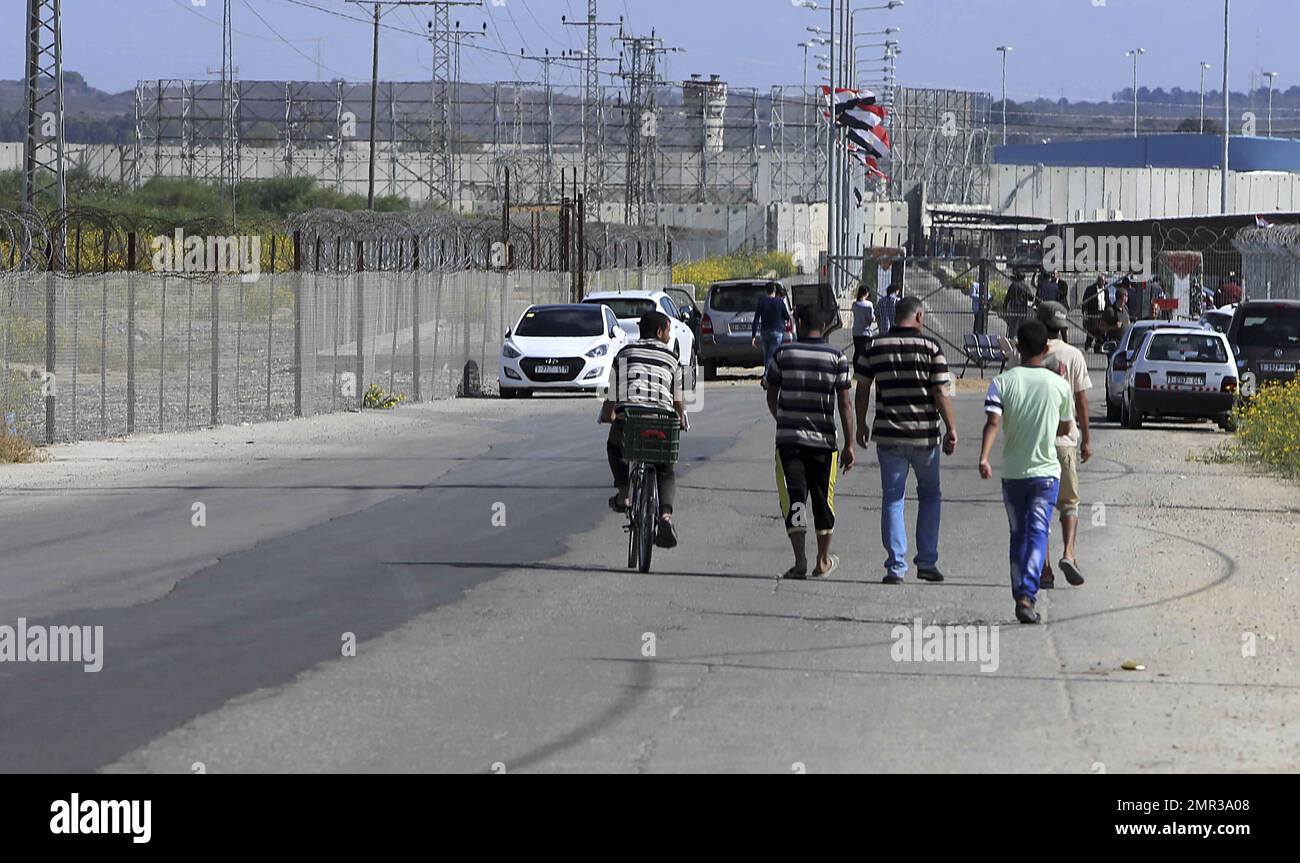 Residents walk towards the Palestinian side of the Erez checkpoint ...