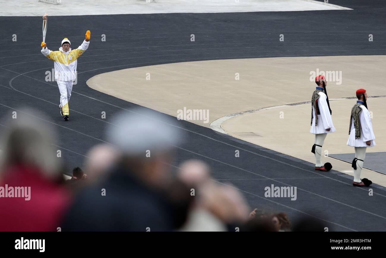 Kim Ki-hoon, three-time gold medalist of the Republic of Korea, carries ...