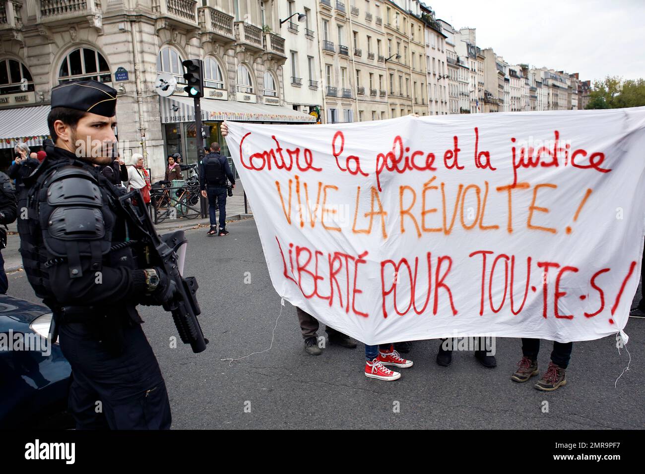 Youths carry a banner reading "Against police and justice, long live ...