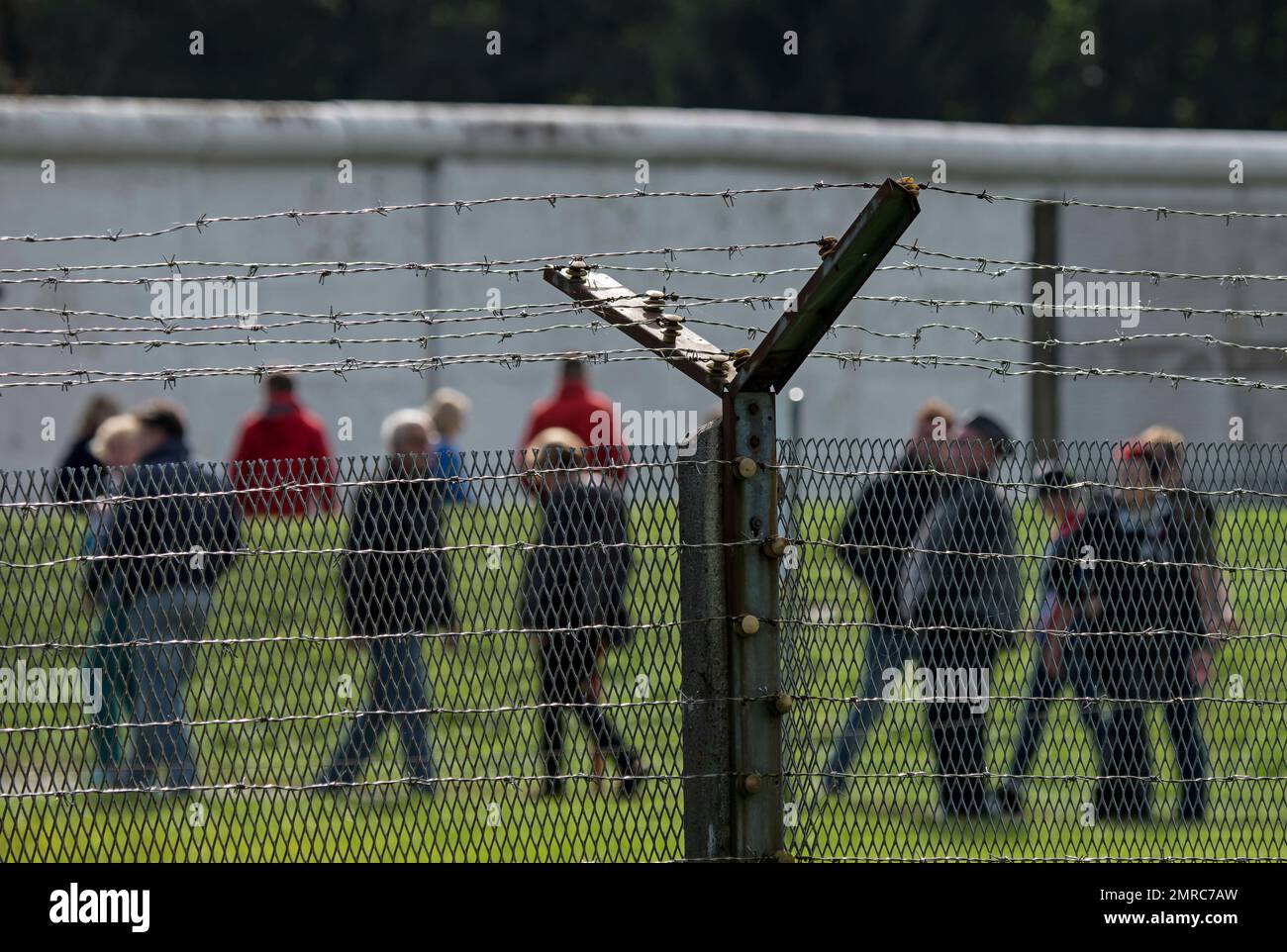 Visitors walk along the former GDR border wall in Moedlareuth, Germany ...