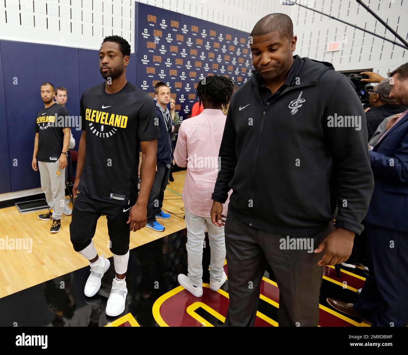 Cleveland Cavaliers' Dwyane Wade, left, leaves a news conference at the ...