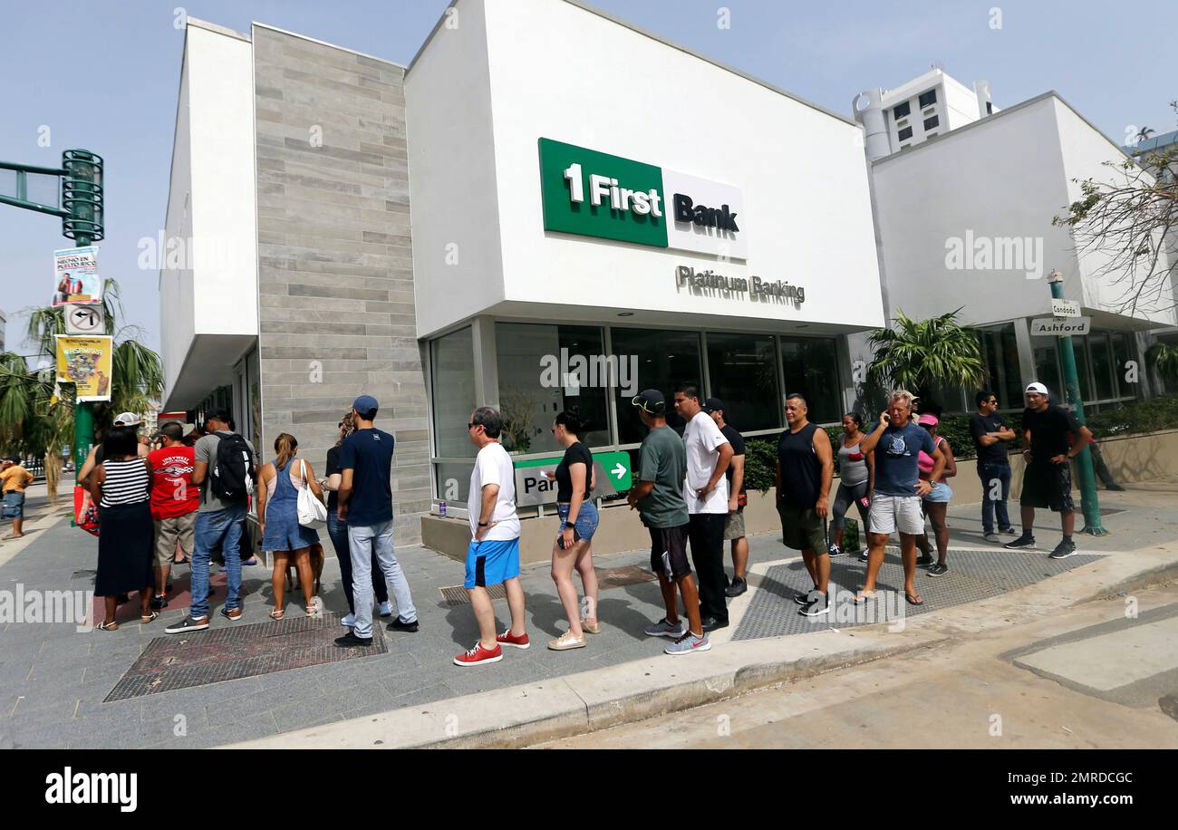 FILE - In this Wednesday, Sept. 27, 2017, file photo, people wait in ...